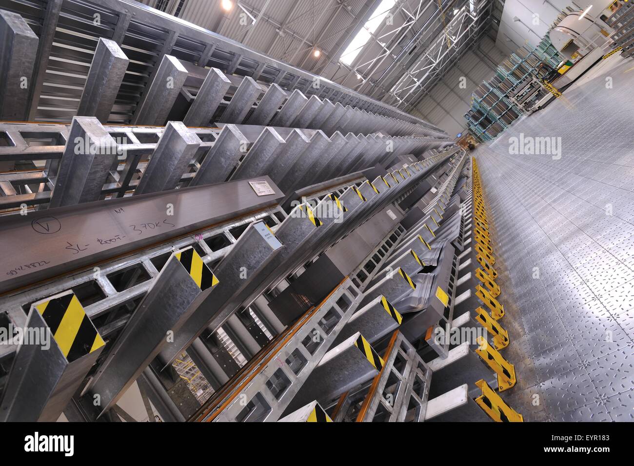 Inside a modern car factory, vehicles and parts move through the ...