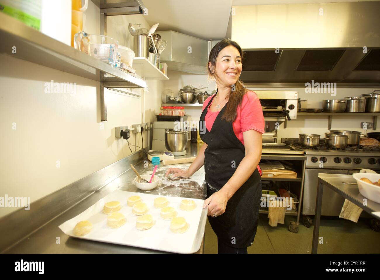 young woman in kitchen making food Stock Photo - Alamy