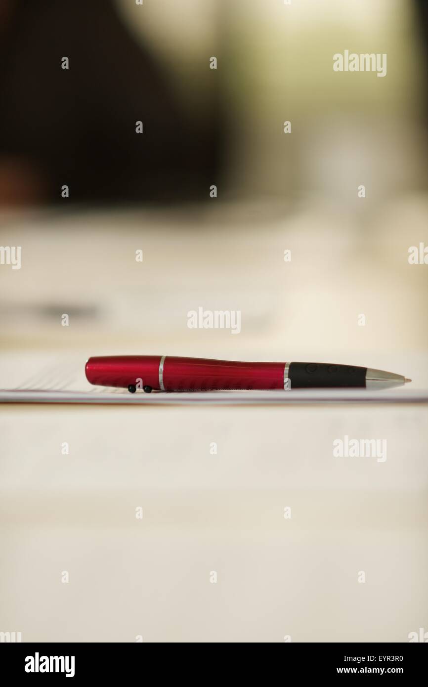 A high quality pen in a meeting room conference centre on some A4 paper ...