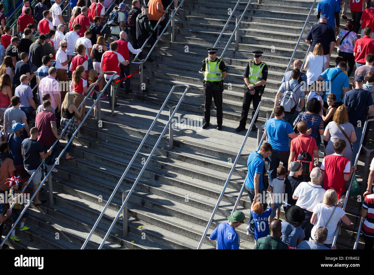 Police stand between football supporters heading to a station following ...