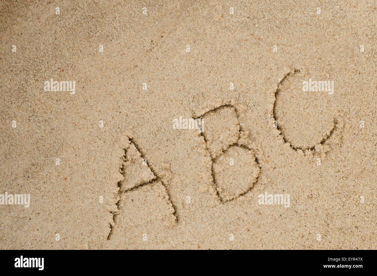 abc letters handwritten on sand Stock Photo - Alamy