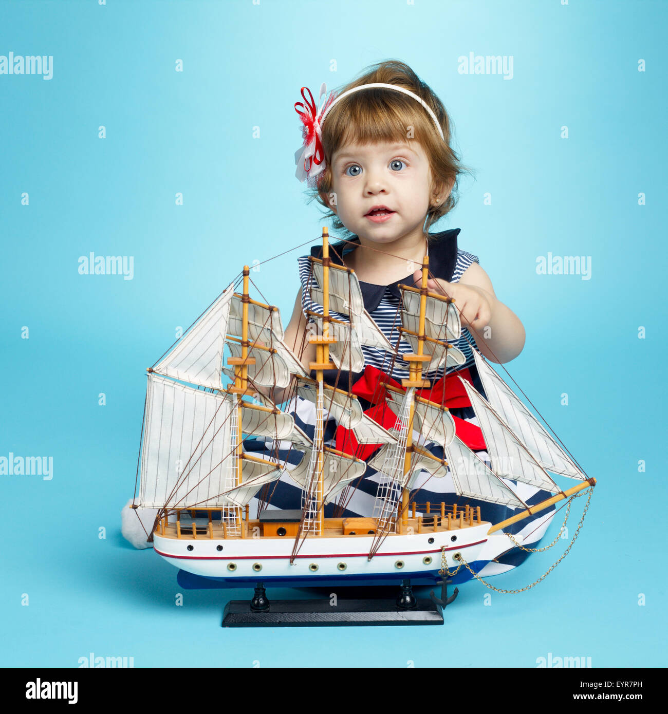 girl in a sea clothes with model ship Stock Photo - Alamy