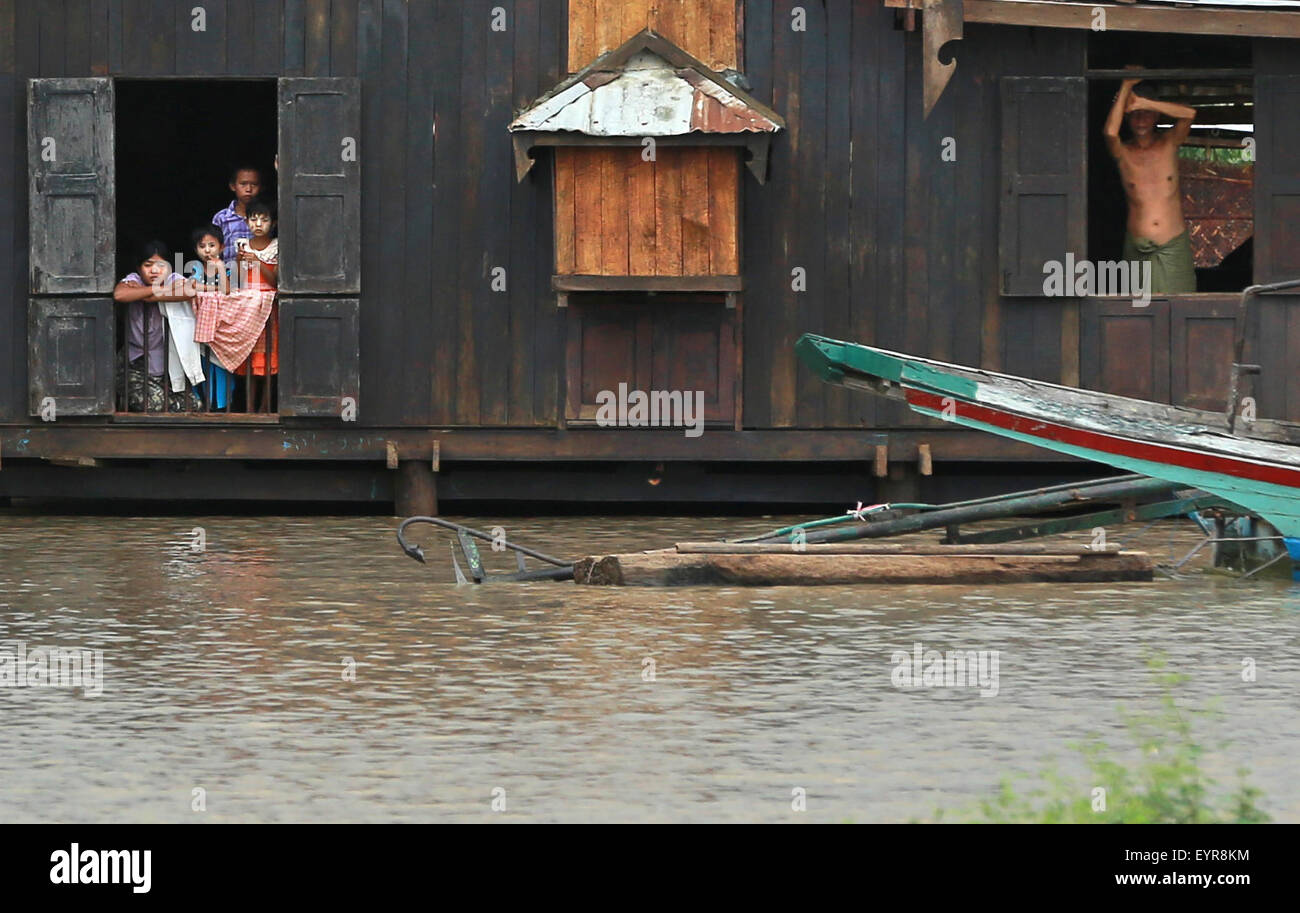 Magway Region, Myanmar. 3rd Aug, 2015. Local residents look out from ...