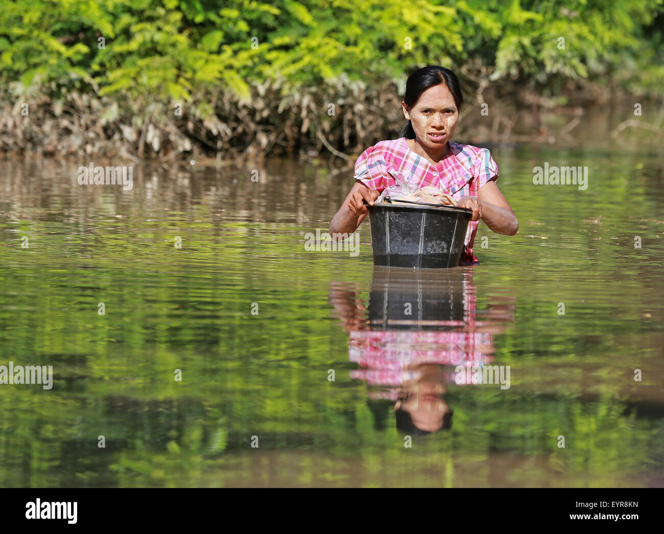 Magway Region, Myanmar. 3rd Aug, 2015. A local resident carries her ...