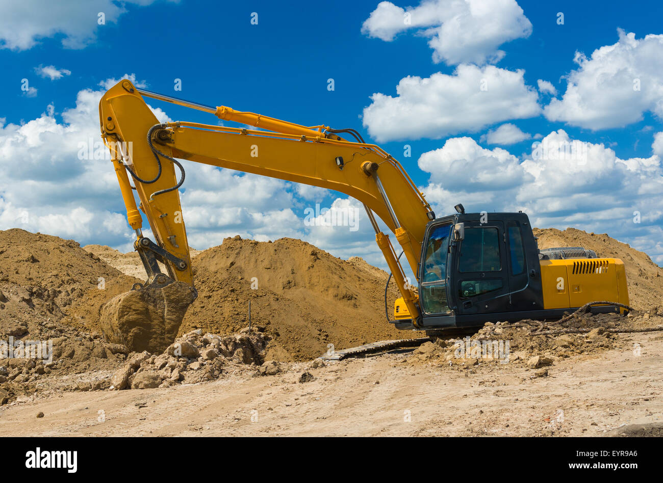 Construction scenery - excavator in trench Stock Photo - Alamy