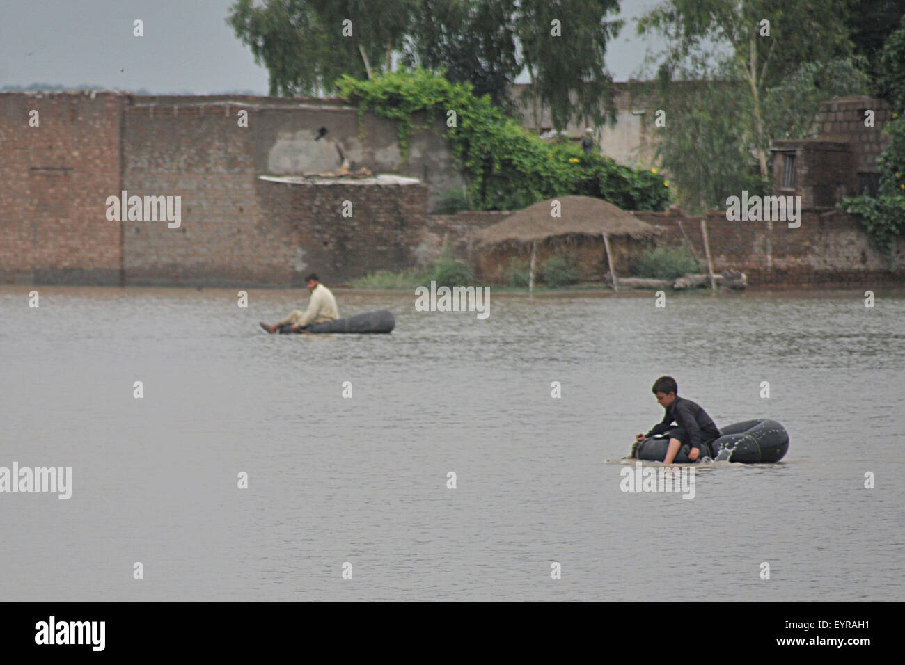 Peshawar, Pakistan. 3rd Aug, 2015. Pakistani flood-affected people go ...