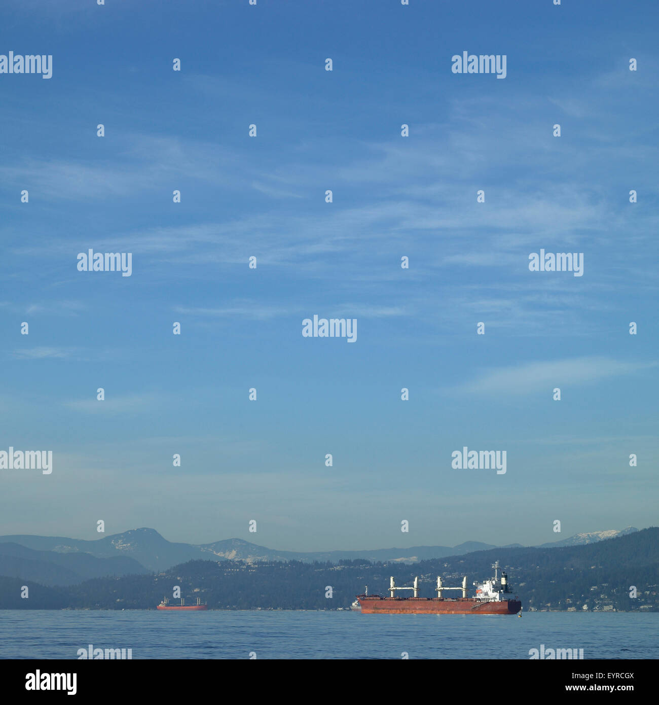 Large vessel on the ocean with mountains in the background Stock Photo ...