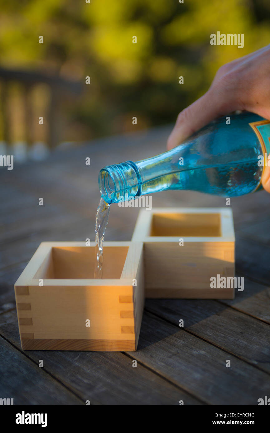 Pouring High End Sake in to Traditional Wooden Cups Stock Photo - Alamy