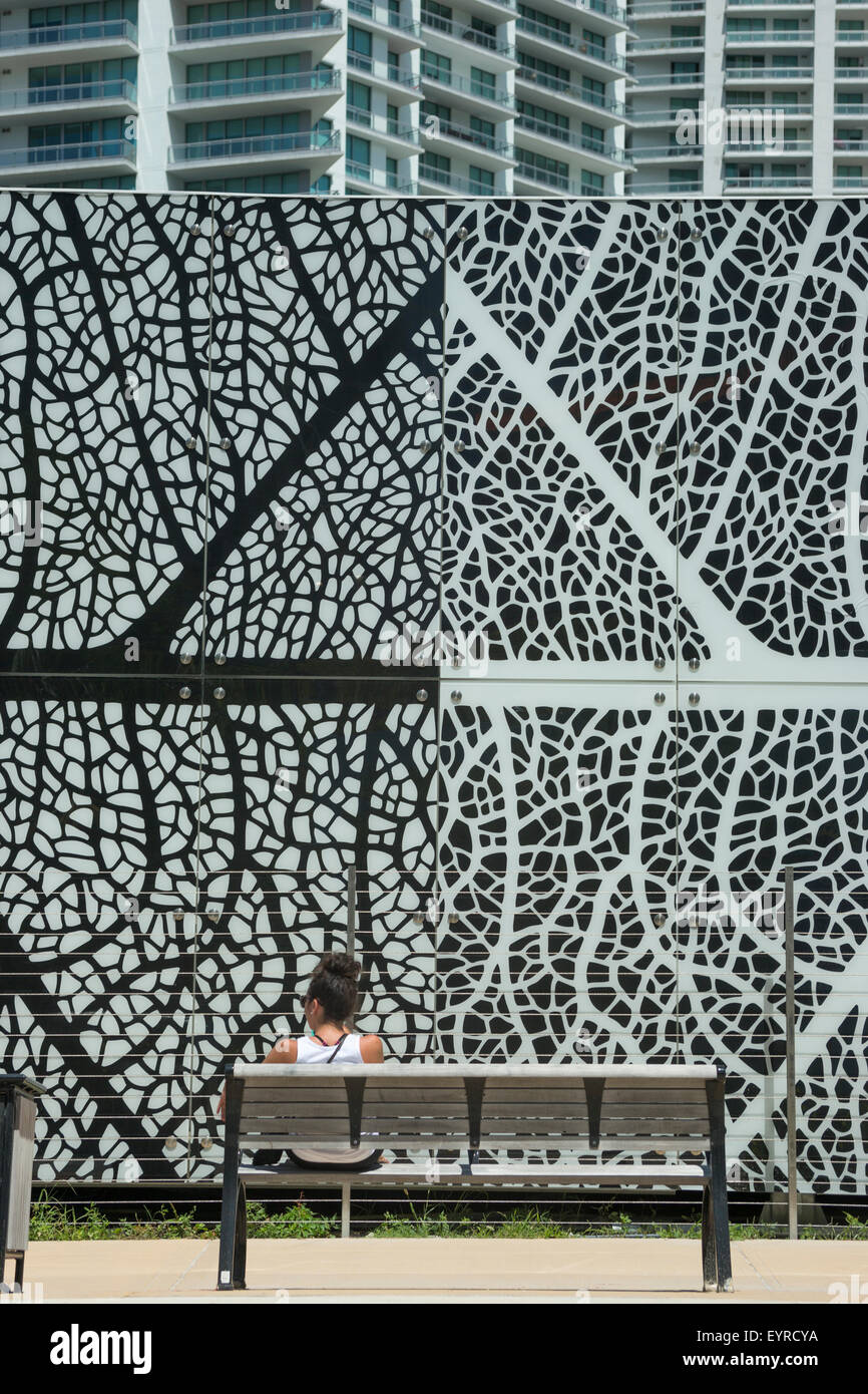WOMAN SITTING ON PUBLIC BENCH LEAF PATTERN ART PANELS FIFTH STREET ...