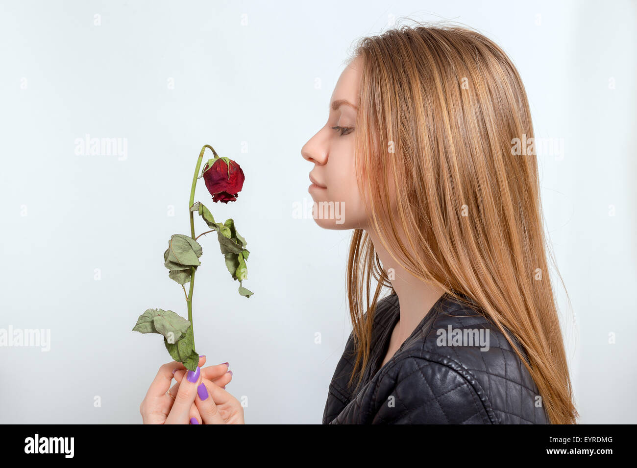 sad woman with dried rose on white background Stock Photo - Alamy