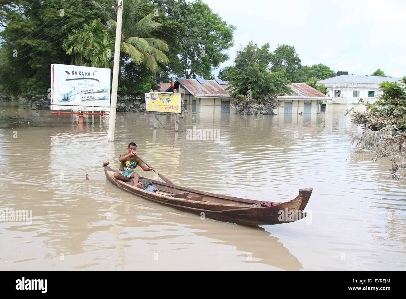 Kalay, Myanmar. 3rd Aug, 2015. A resident paddles his boat in a flooded ...