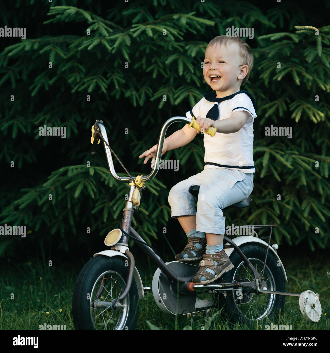 little happy boy on bike Stock Photo - Alamy