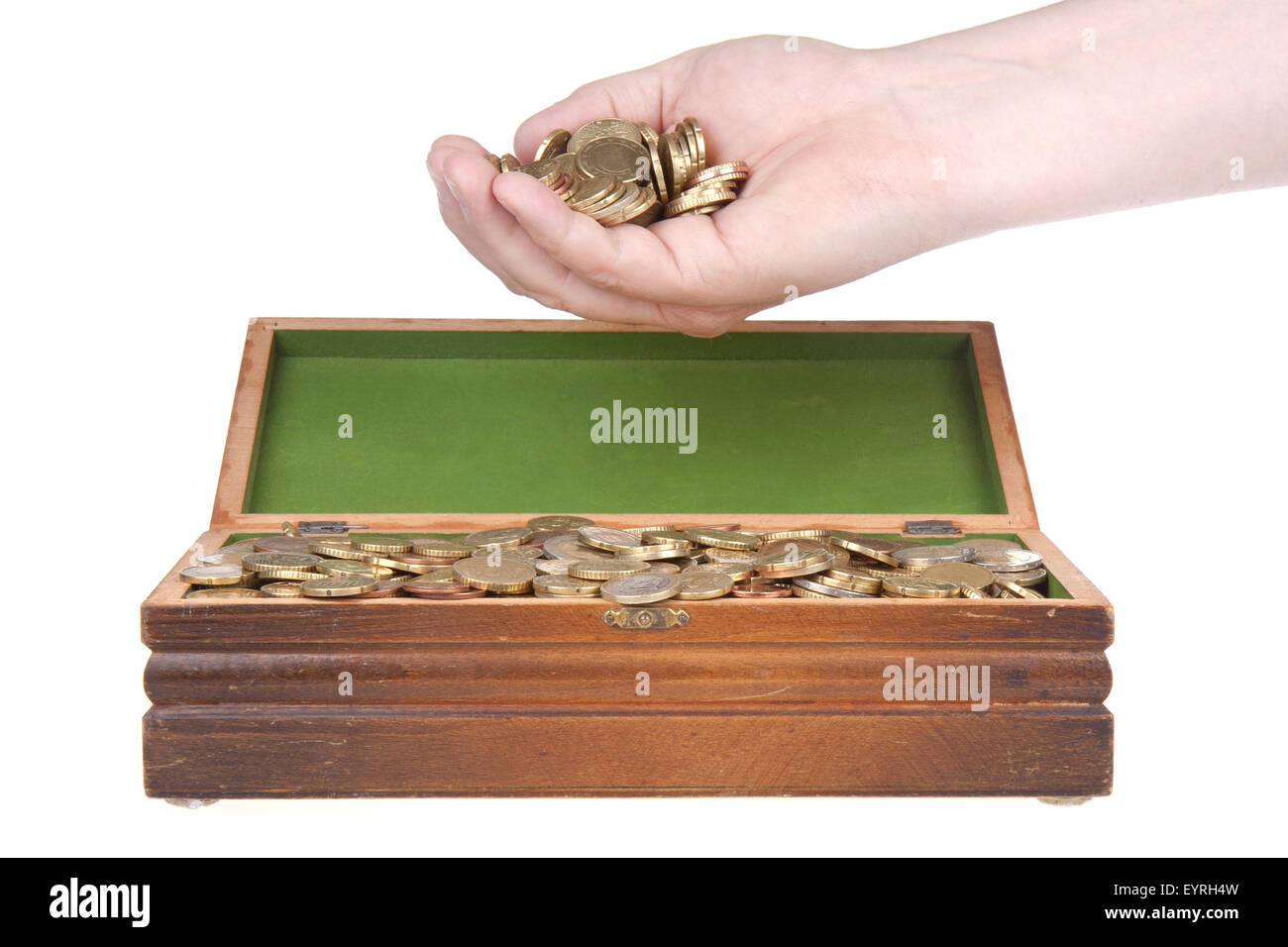 Hand full of coins over a treasure chest Stock Photo - Alamy