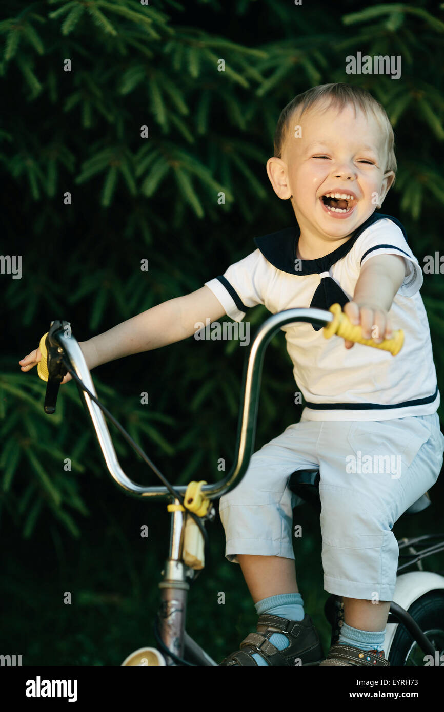 little happy boy on bike Stock Photo - Alamy
