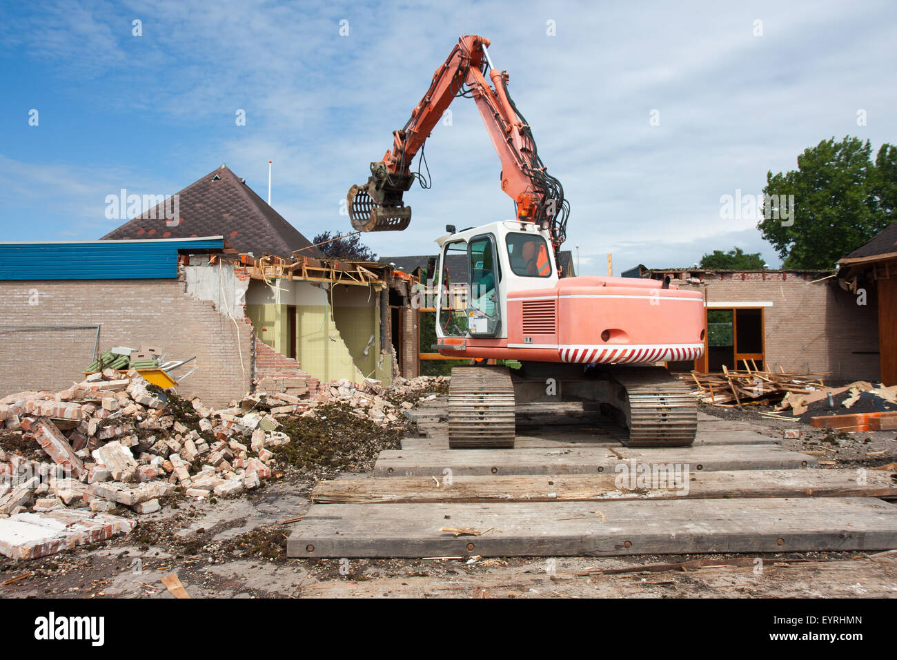 Destruction of a building by a caterpillar crane Stock Photo - Alamy