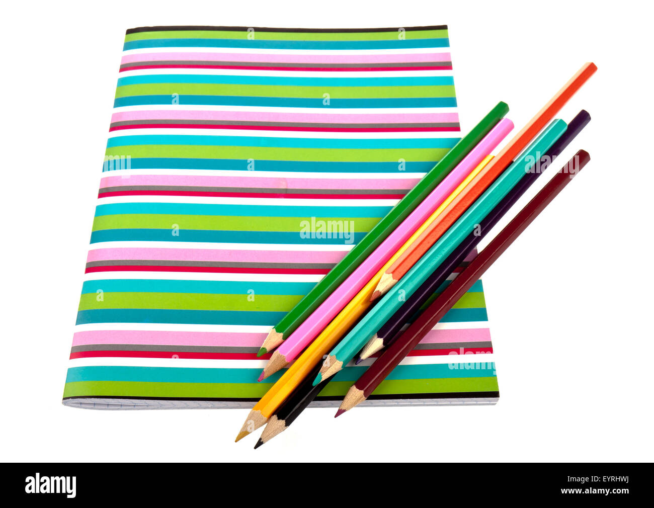 Exercise book with colorful pencils Stock Photo - Alamy
