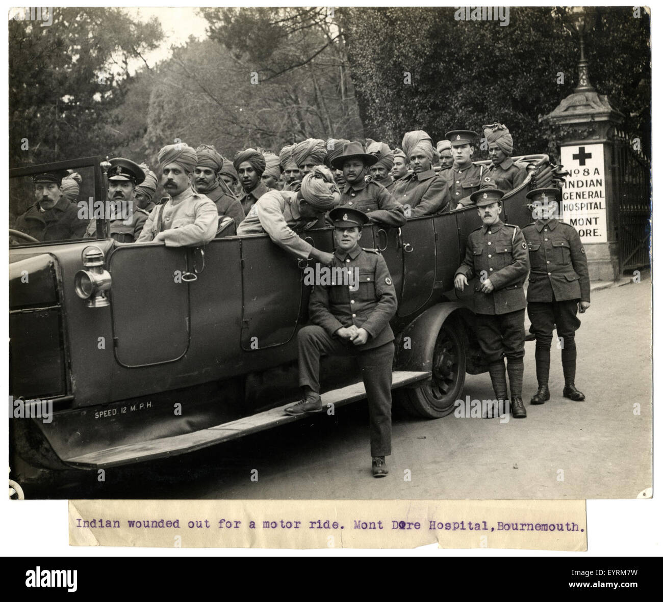 Photograph showing an Indian soldier who was wounded, taking a motor ...