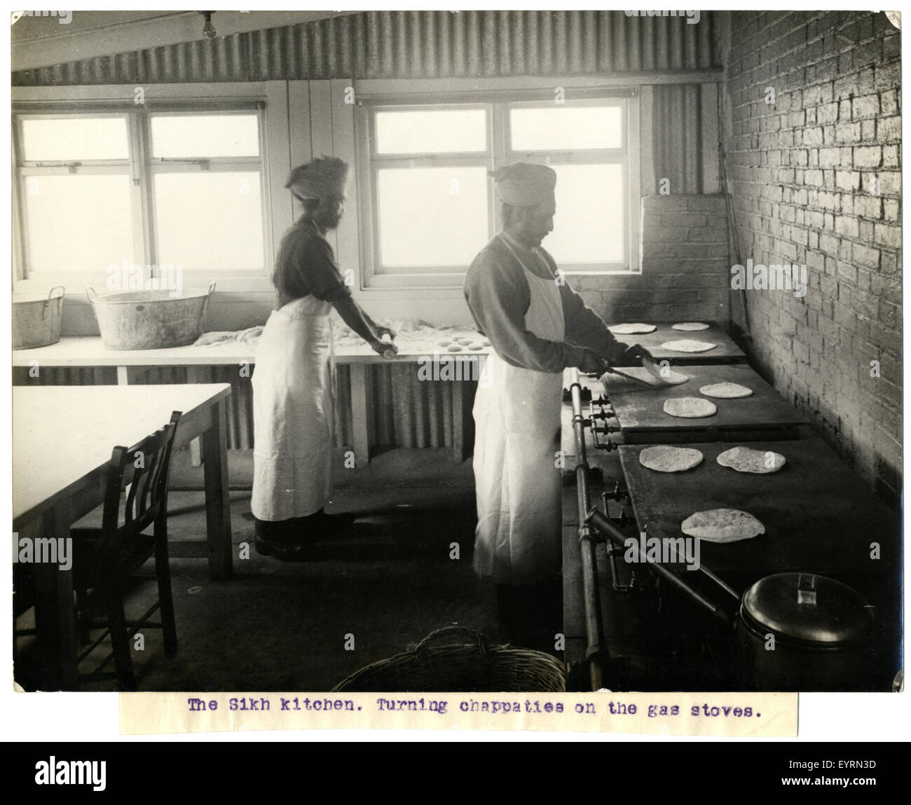This image depicts a traditional Sikh kitchen in Brighton, with a focus ...