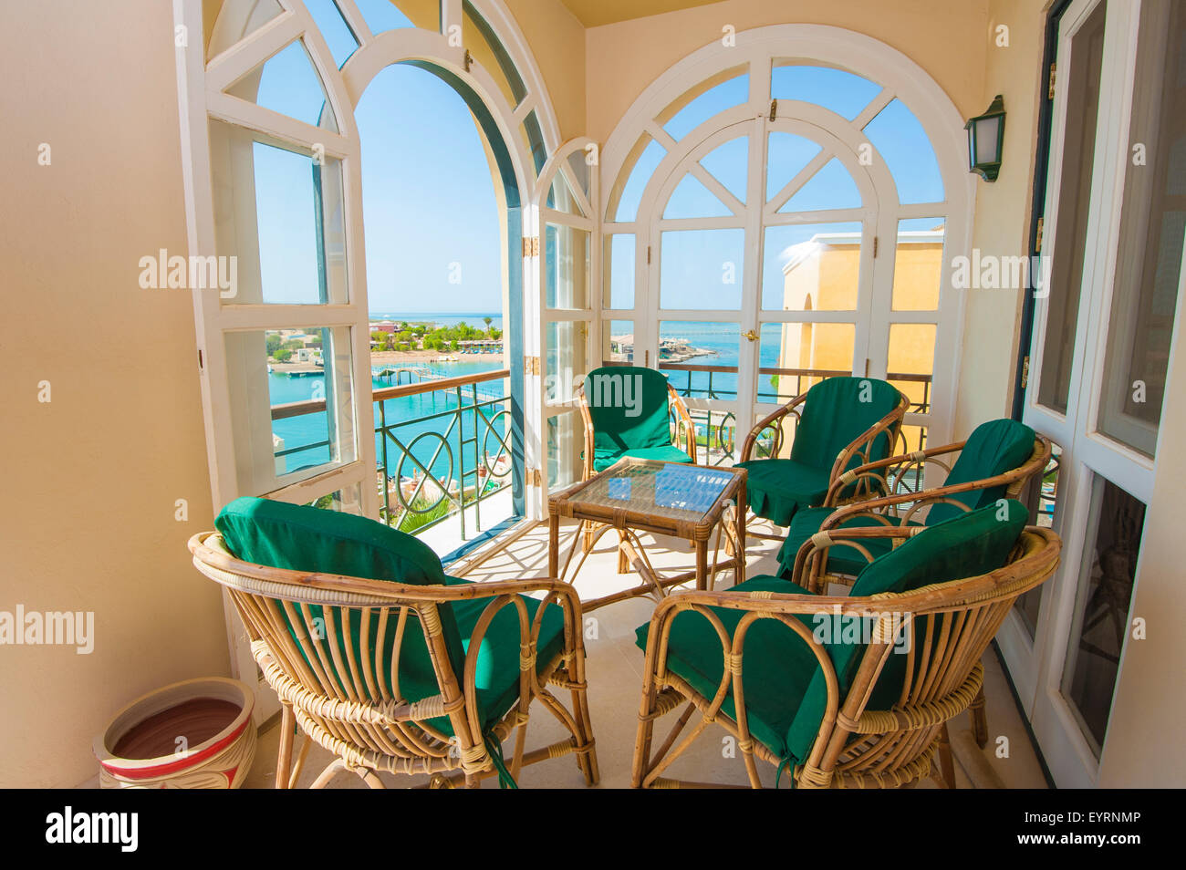 Chairs and table on balcony of a luxury villa in tropical resort with ...