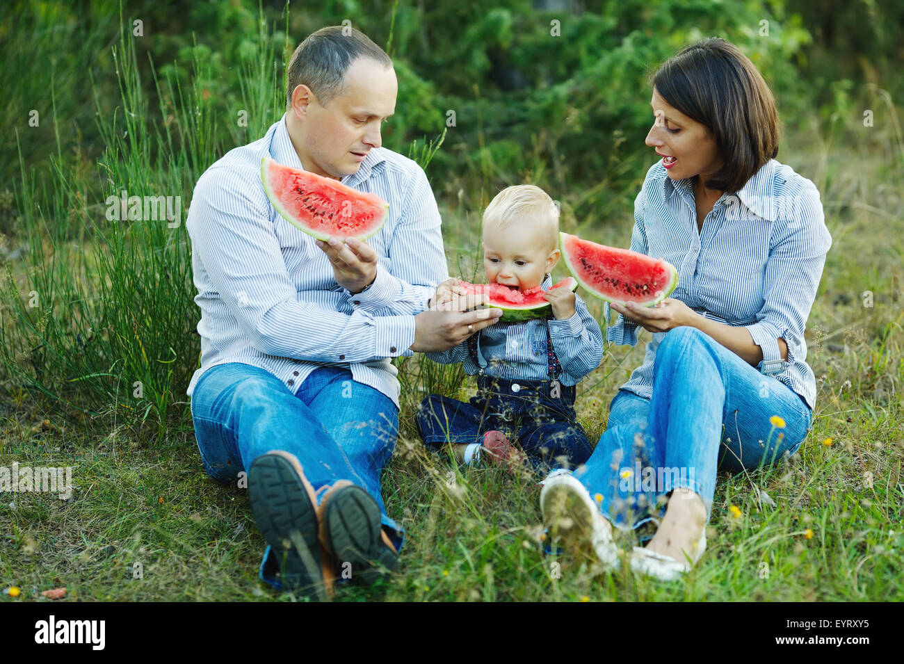 family eating watermelon Stock Photo - Alamy