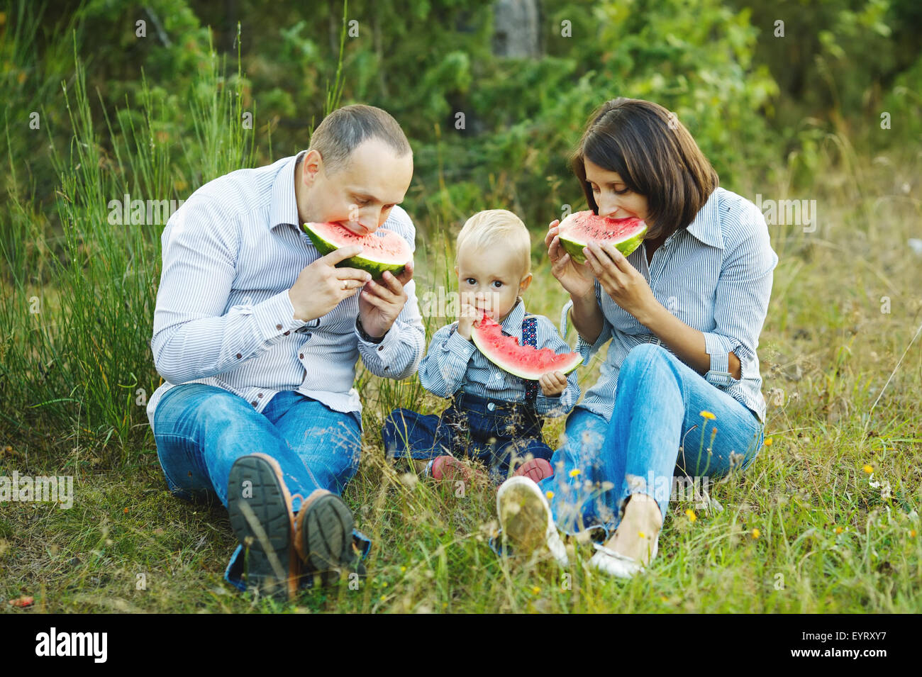 family eating watermelon Stock Photo - Alamy