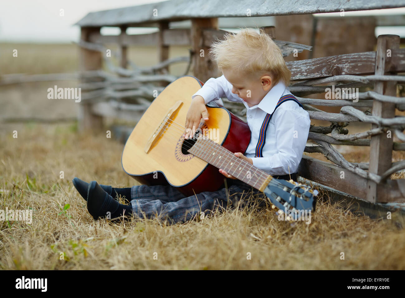 little boy with guitar on location Stock Photo - Alamy