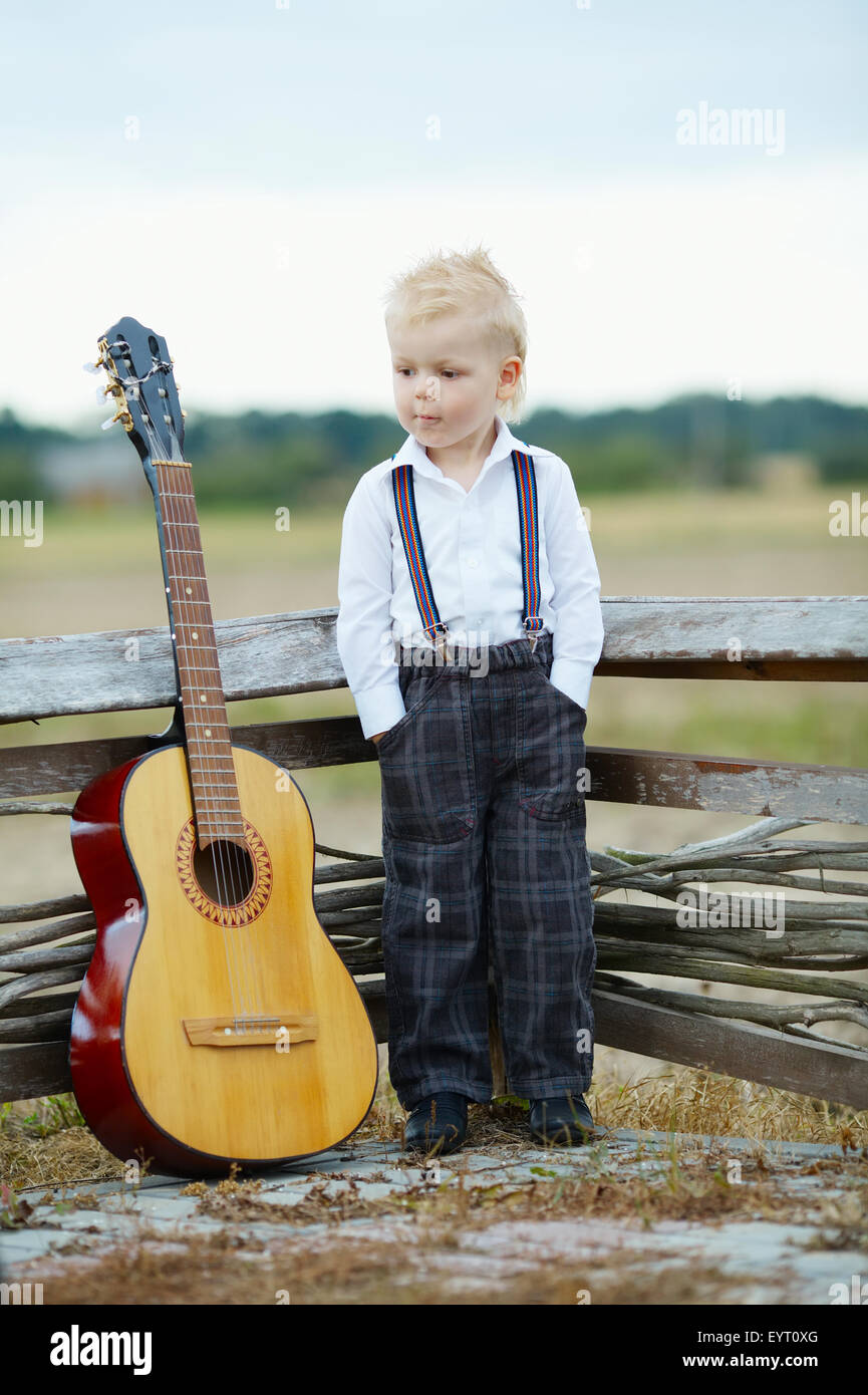 little boy with guitar on location Stock Photo - Alamy