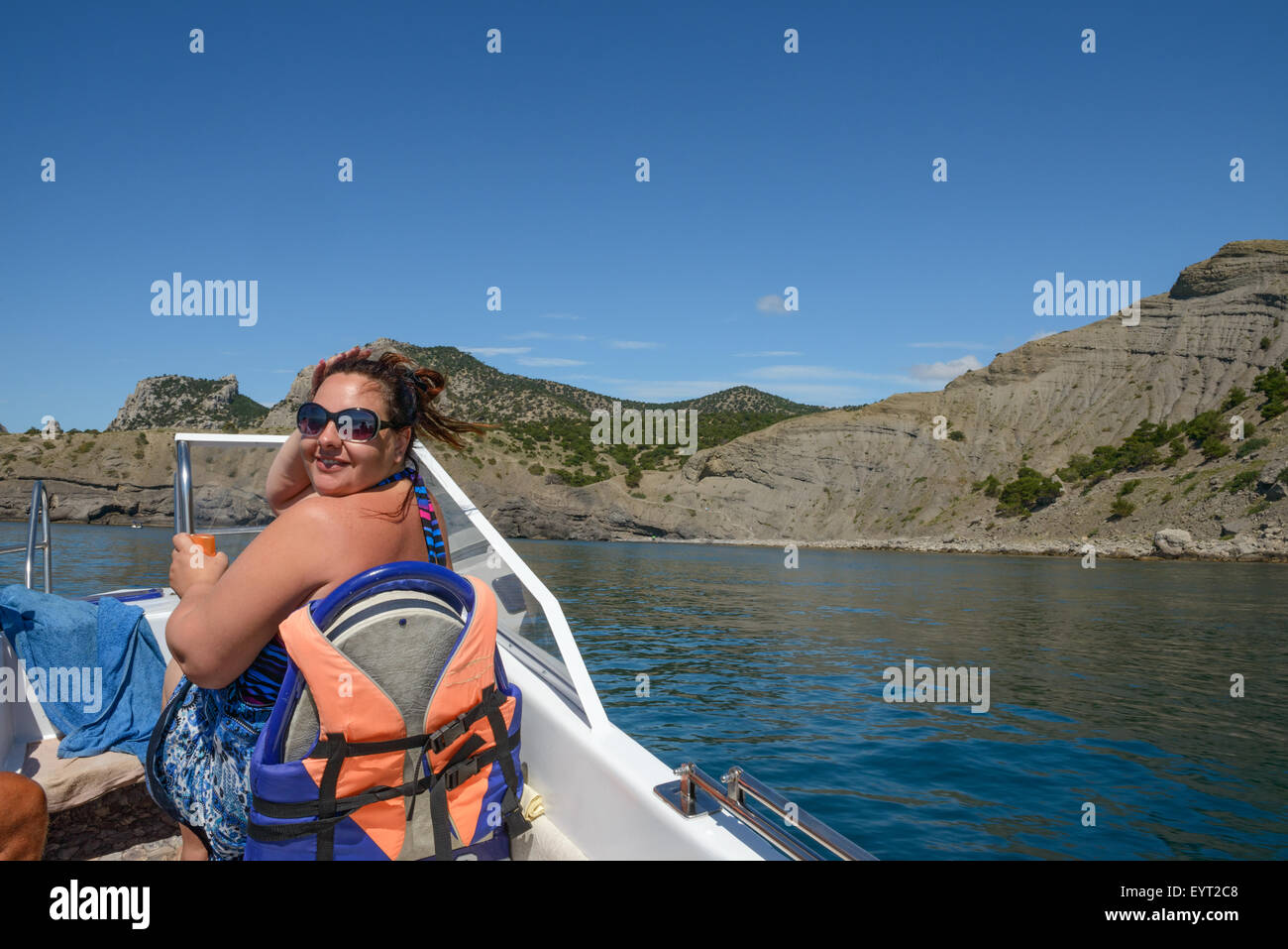 Portrait of mid adult lady that is having journey on the sea boat on ...