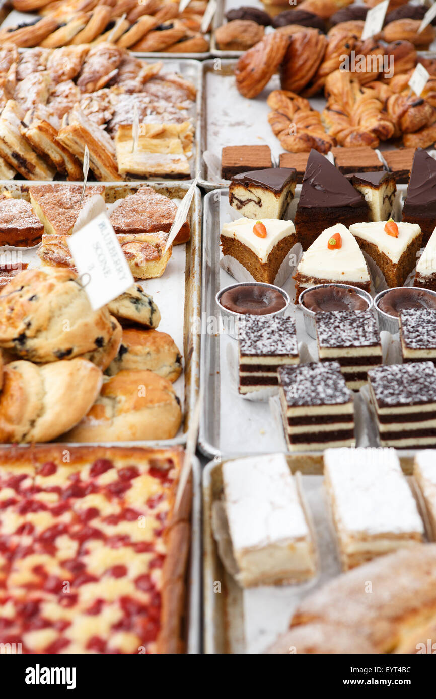 Assortment of many pastries and desserts displayed on bakery trays ...