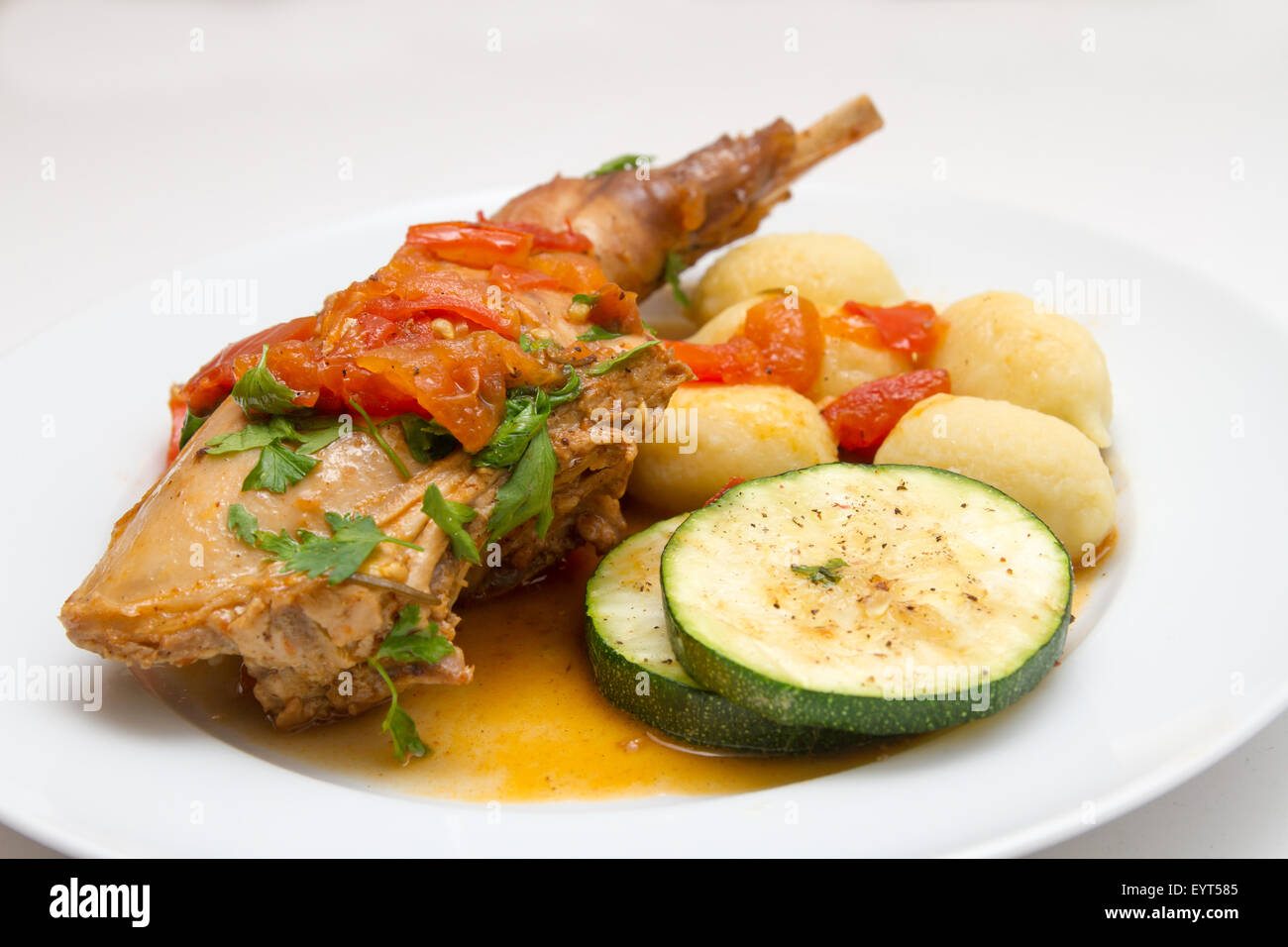 Roast rabbit with gnocchi and zucchini Stock Photo - Alamy