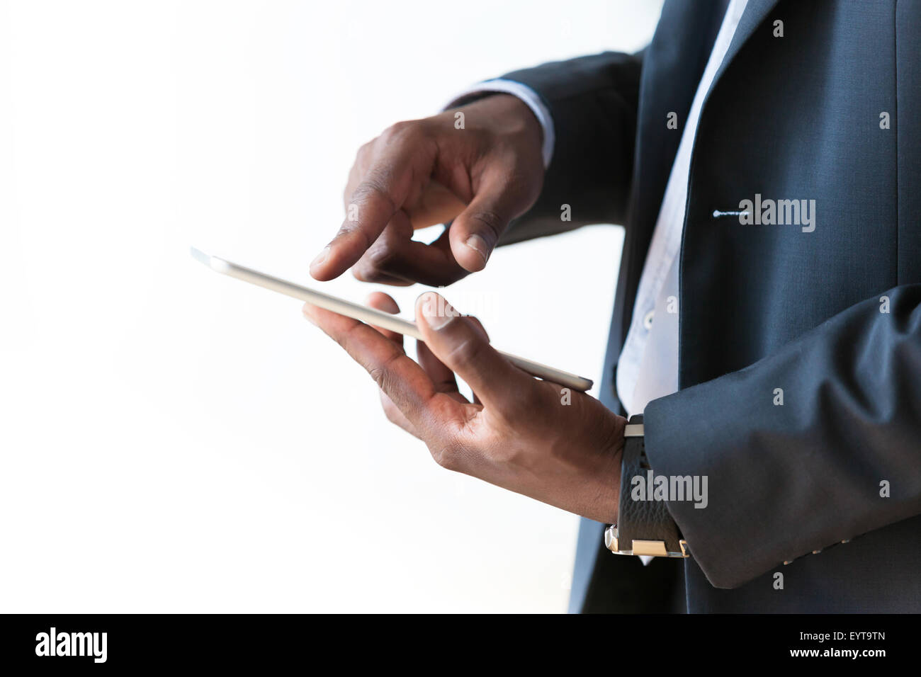 African american business man using a tactile tablet over white ...