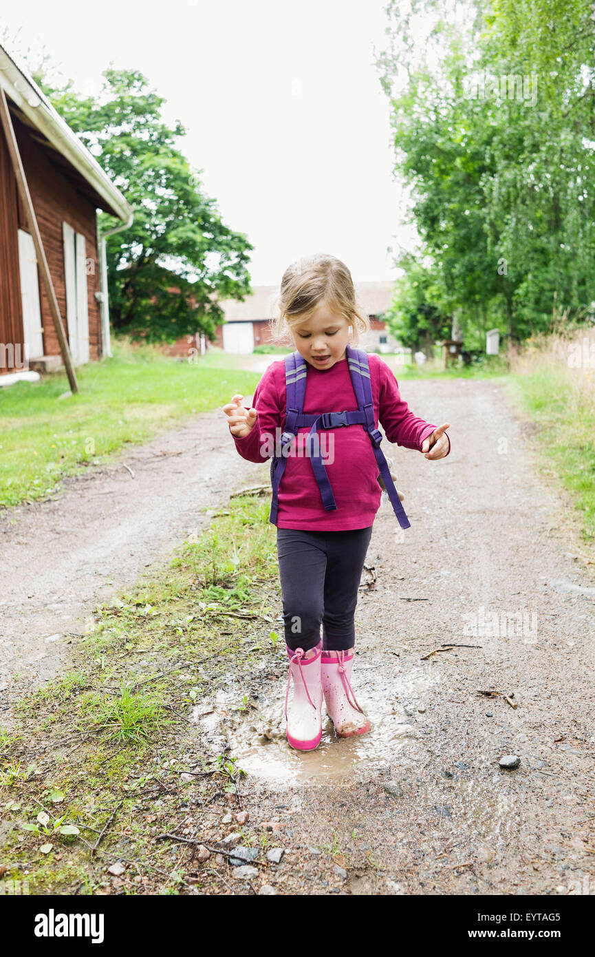 Girls, 3 years old, way, puddle, jumping, playing Stock Photo - Alamy