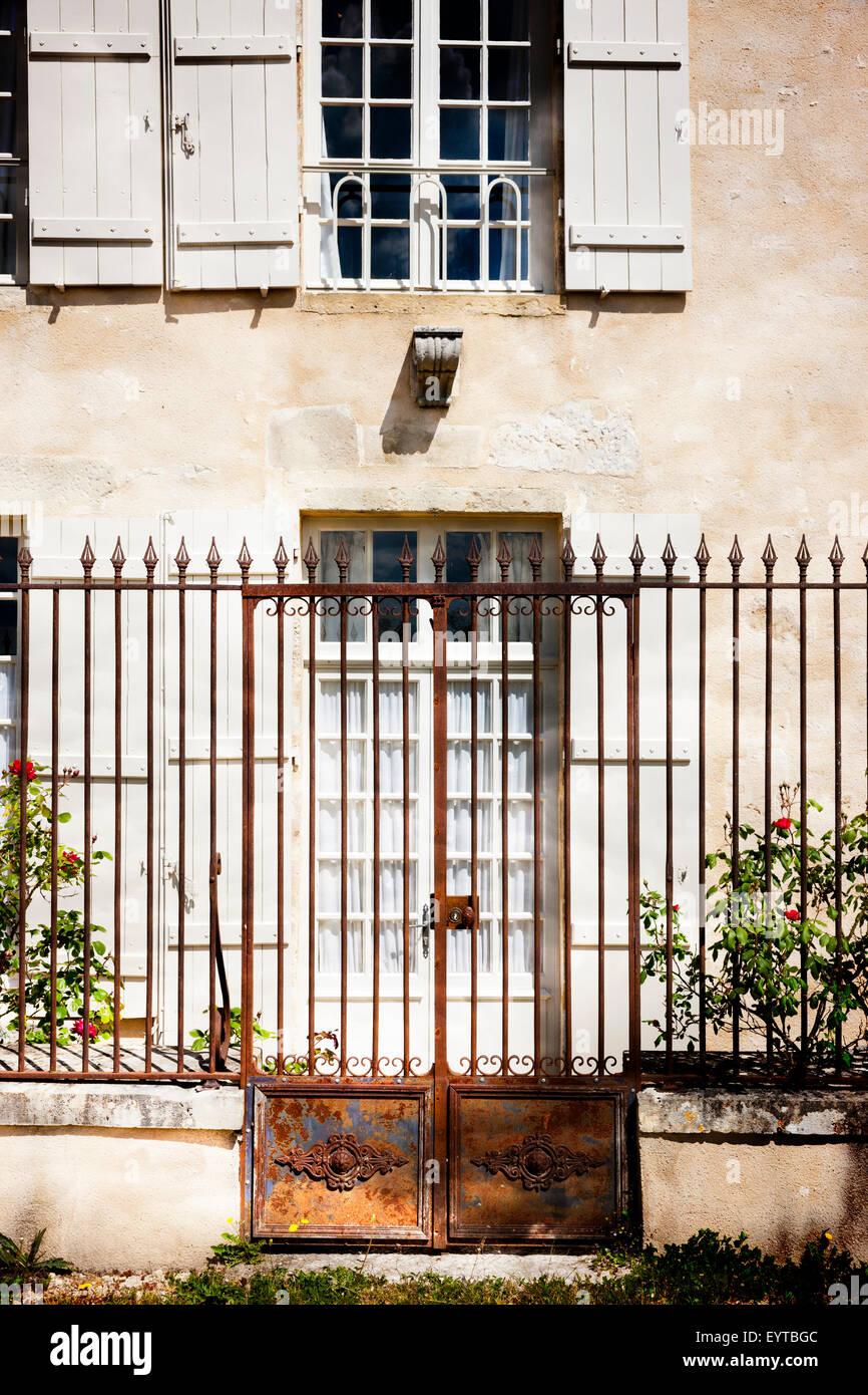 Rusty iron gate in front of old house Stock Photo - Alamy