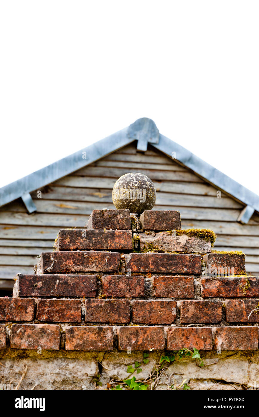 Stone ball on brick wall Stock Photo - Alamy
