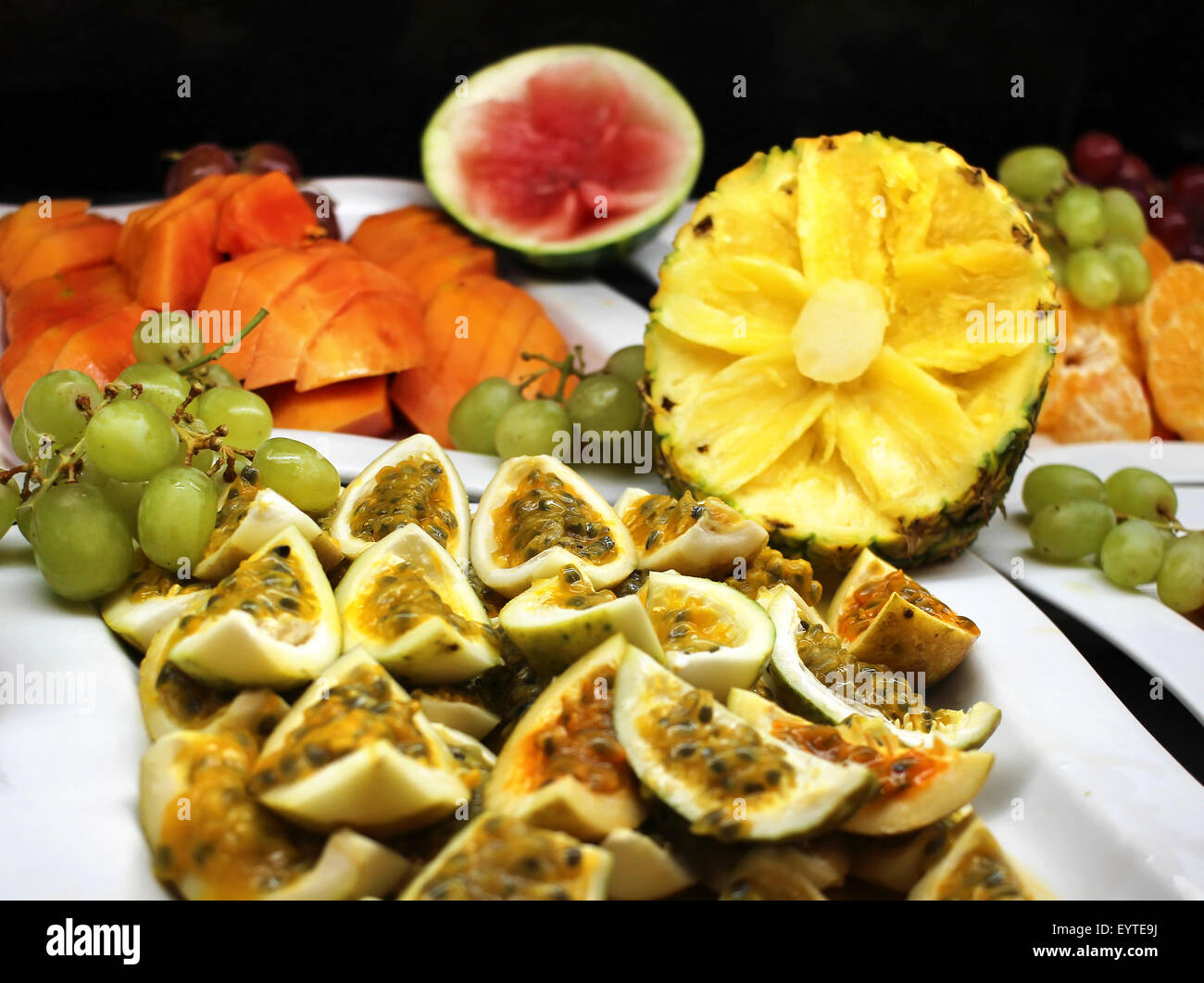 Passion fruit pieces and other tropical fruits Stock Photo - Alamy