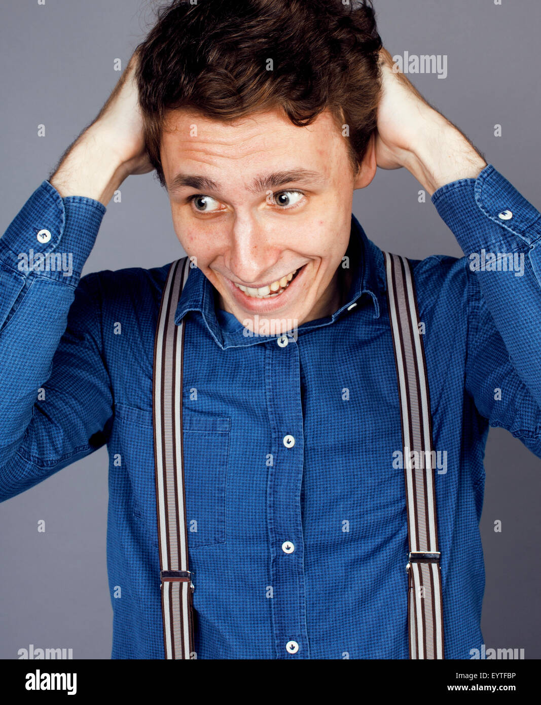 young goofy man with pimples pointing in studio Stock Photo - Alamy