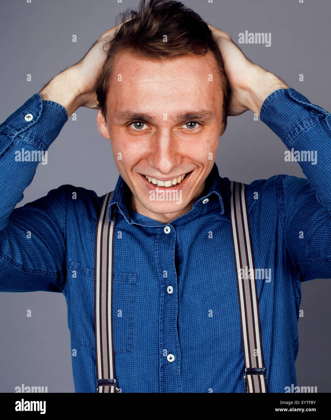 young goofy man with pimples pointing in studio Stock Photo - Alamy
