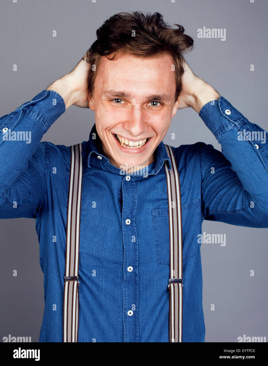 young goofy man with pimples pointing in studio Stock Photo - Alamy