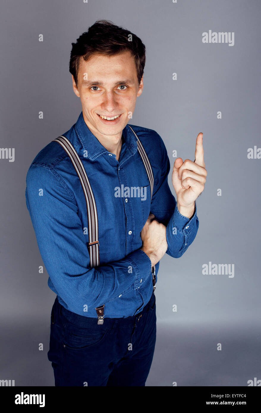 young goofy man with pimples pointing in studio Stock Photo - Alamy