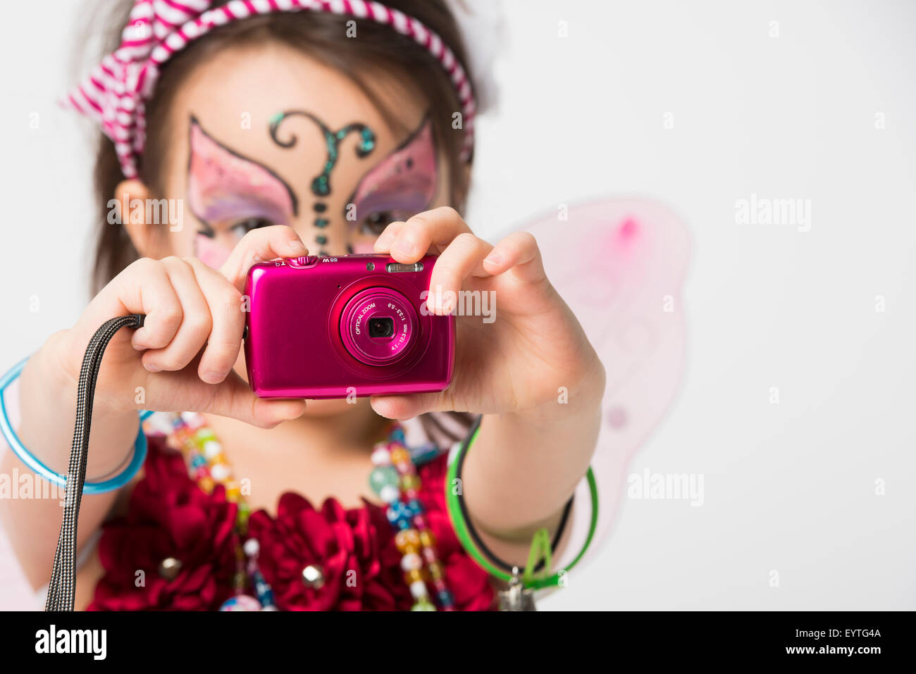 Little girl with face painting holding a snapshot camera Stock Photo ...