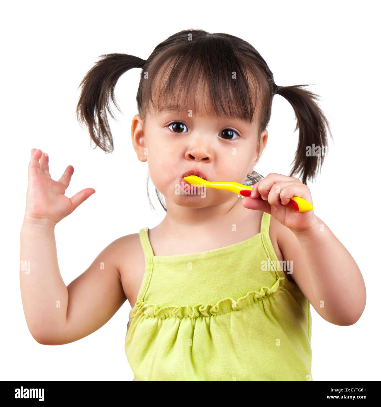 Toddler doing dancing moves while brushing her teeth Stock Photo - Alamy
