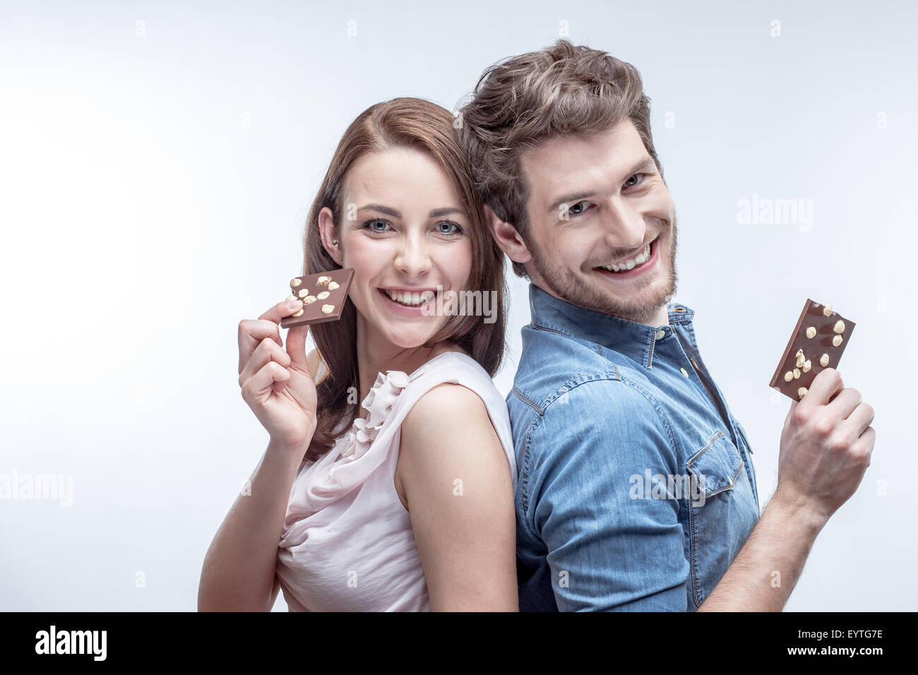Young couple in love with a shared bar of chocolate Stock Photo - Alamy