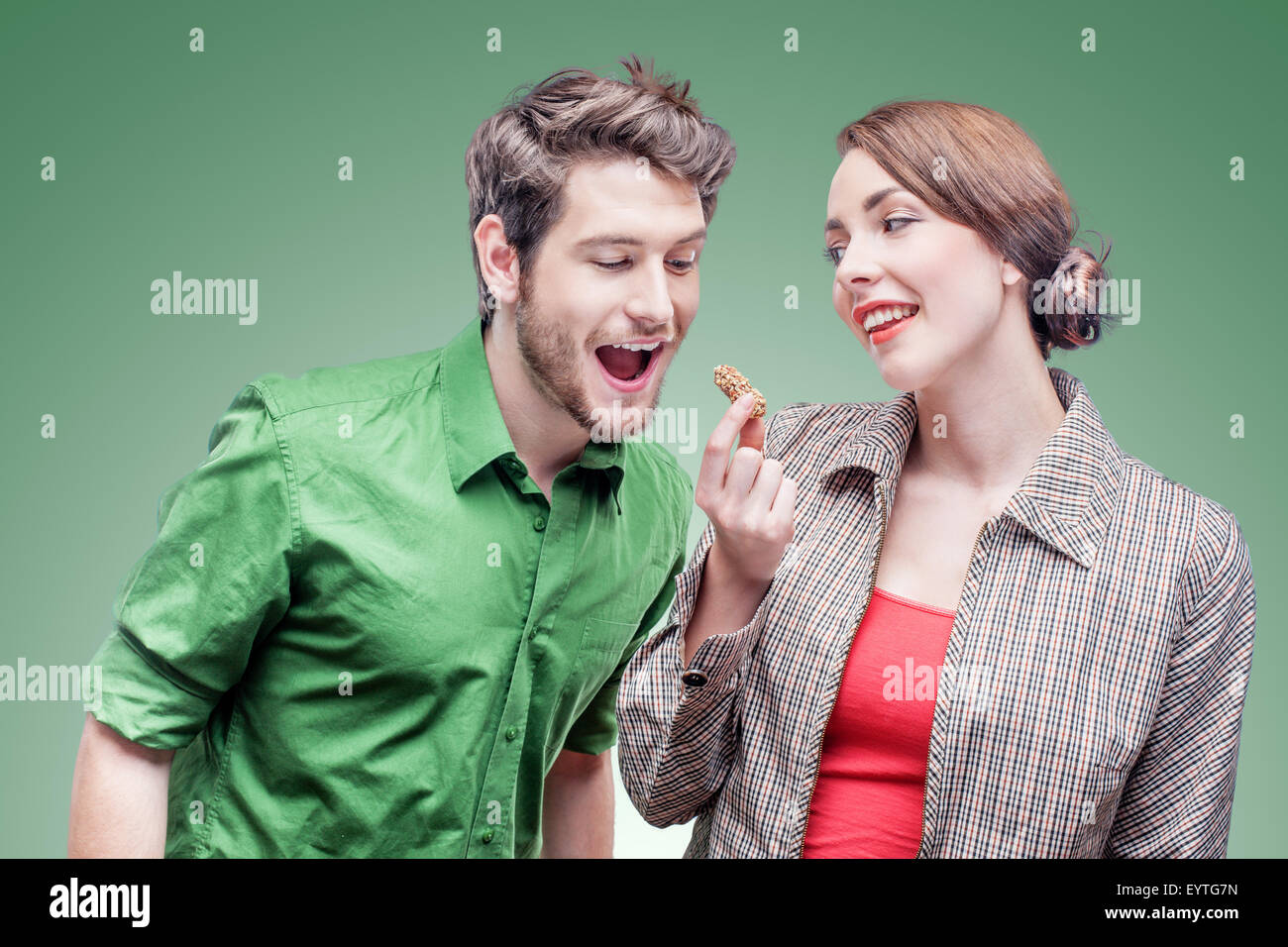 Young couple in love teasing each other with a chocolate Stock Photo ...