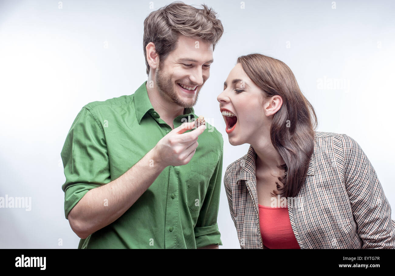 Young couple in love teasing each other with a chocolate Stock Photo ...