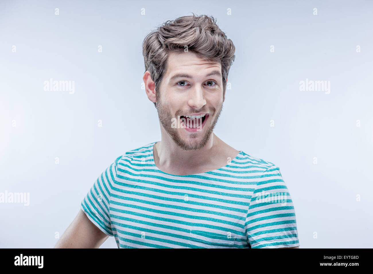 Young man looking surprised Stock Photo - Alamy