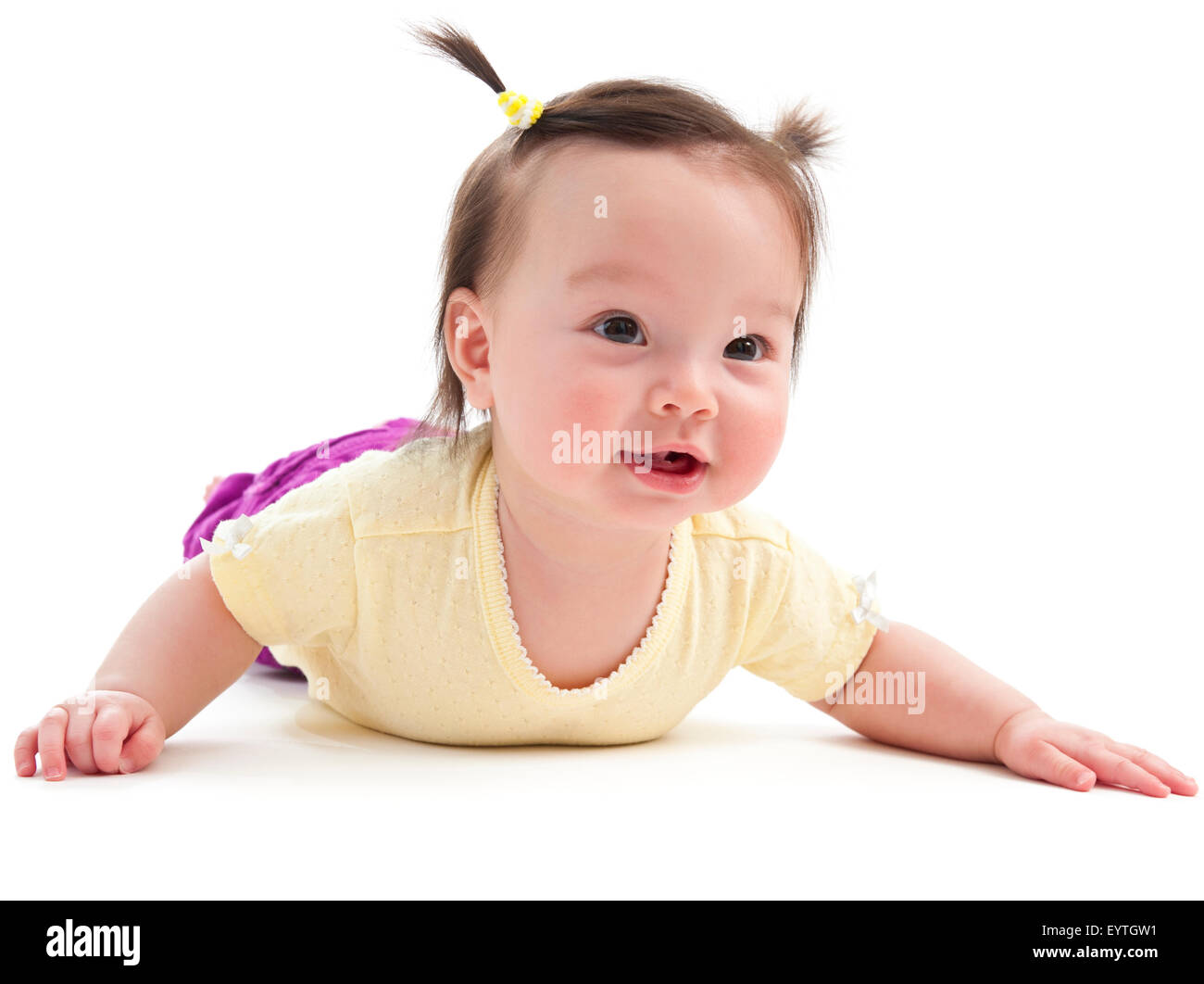 Baby girl smiling posing on her belly. Picture on white background ...
