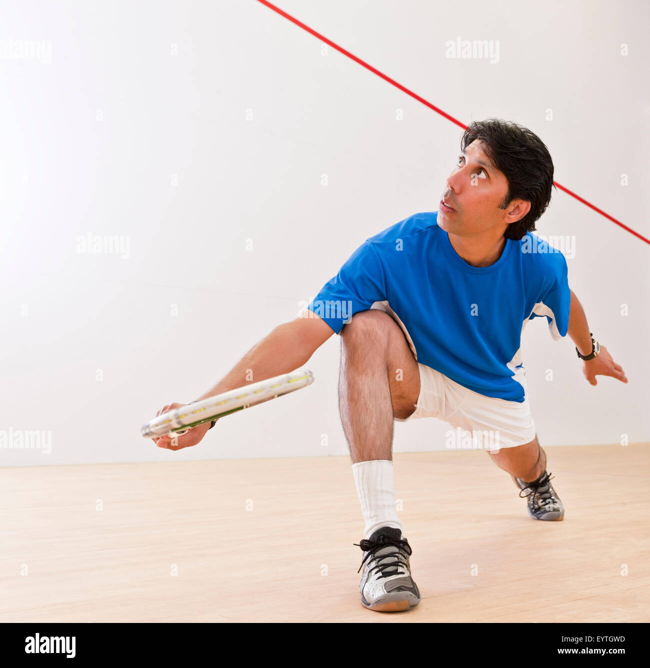 Squash player hiting a backhand lob shot in a squash court Stock Photo ...