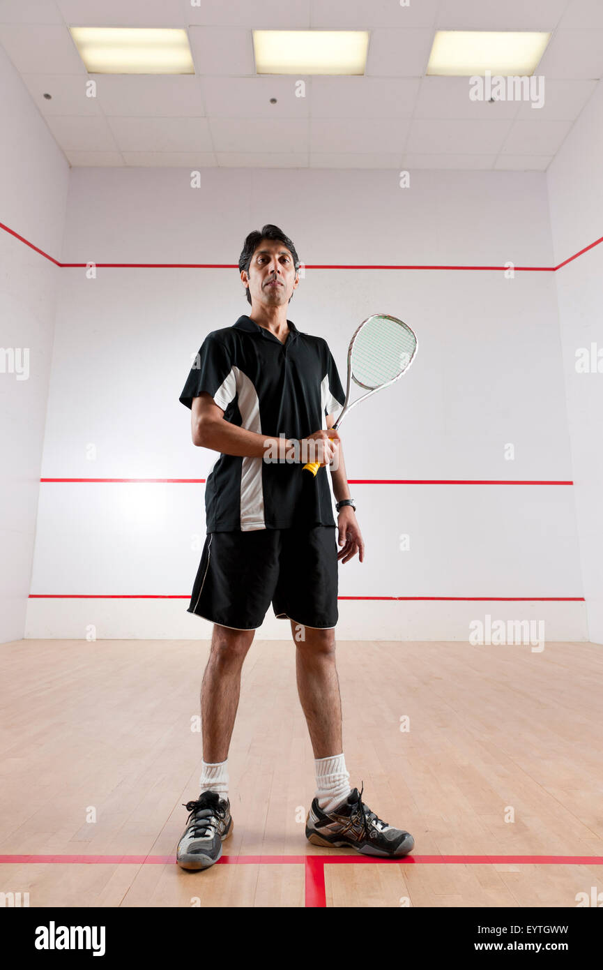 Squash player standing at the T linein a squash court Stock Photo - Alamy