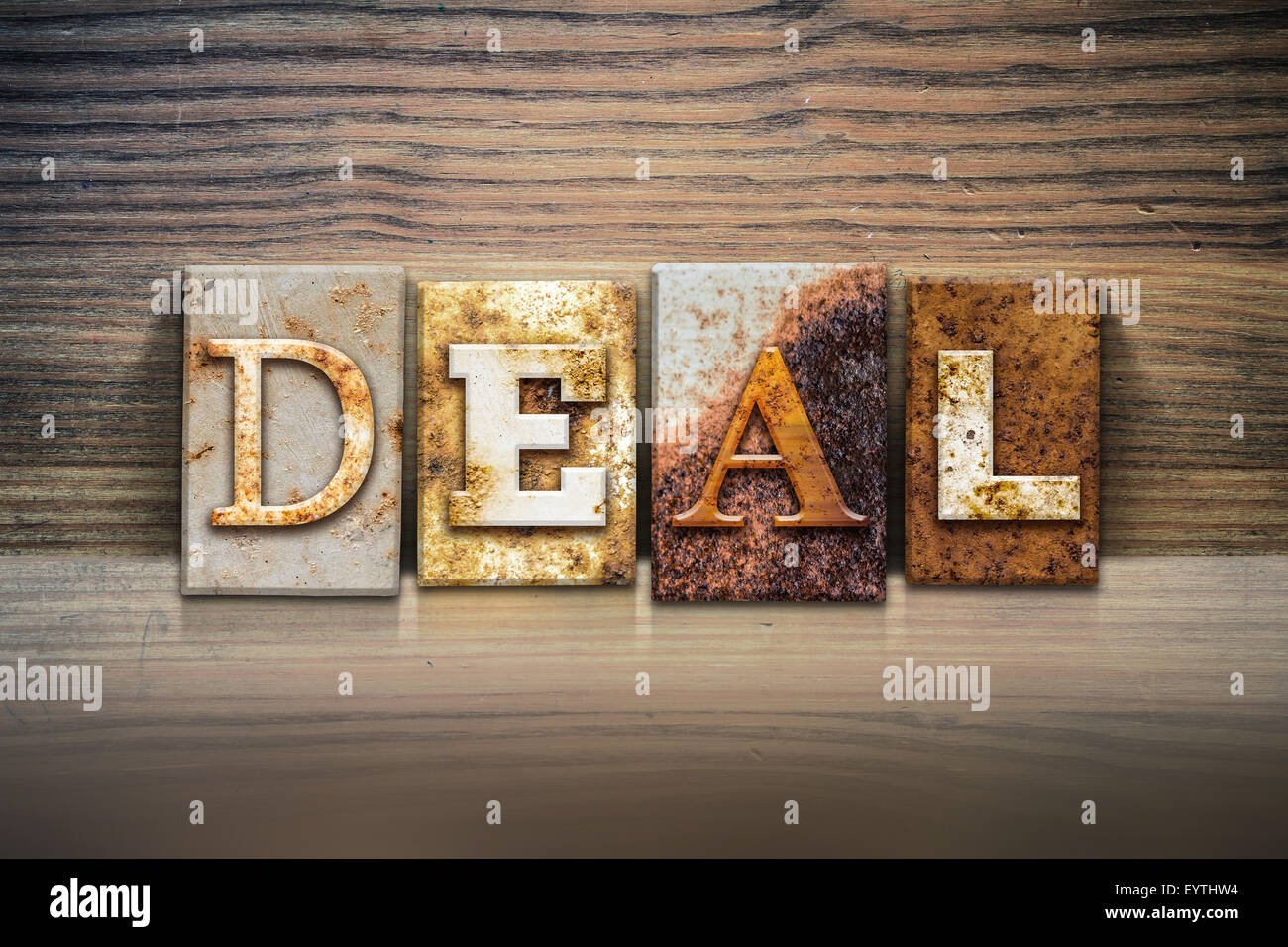 The word "DEAL" written in rusty metal letterpress type sitting on a ...