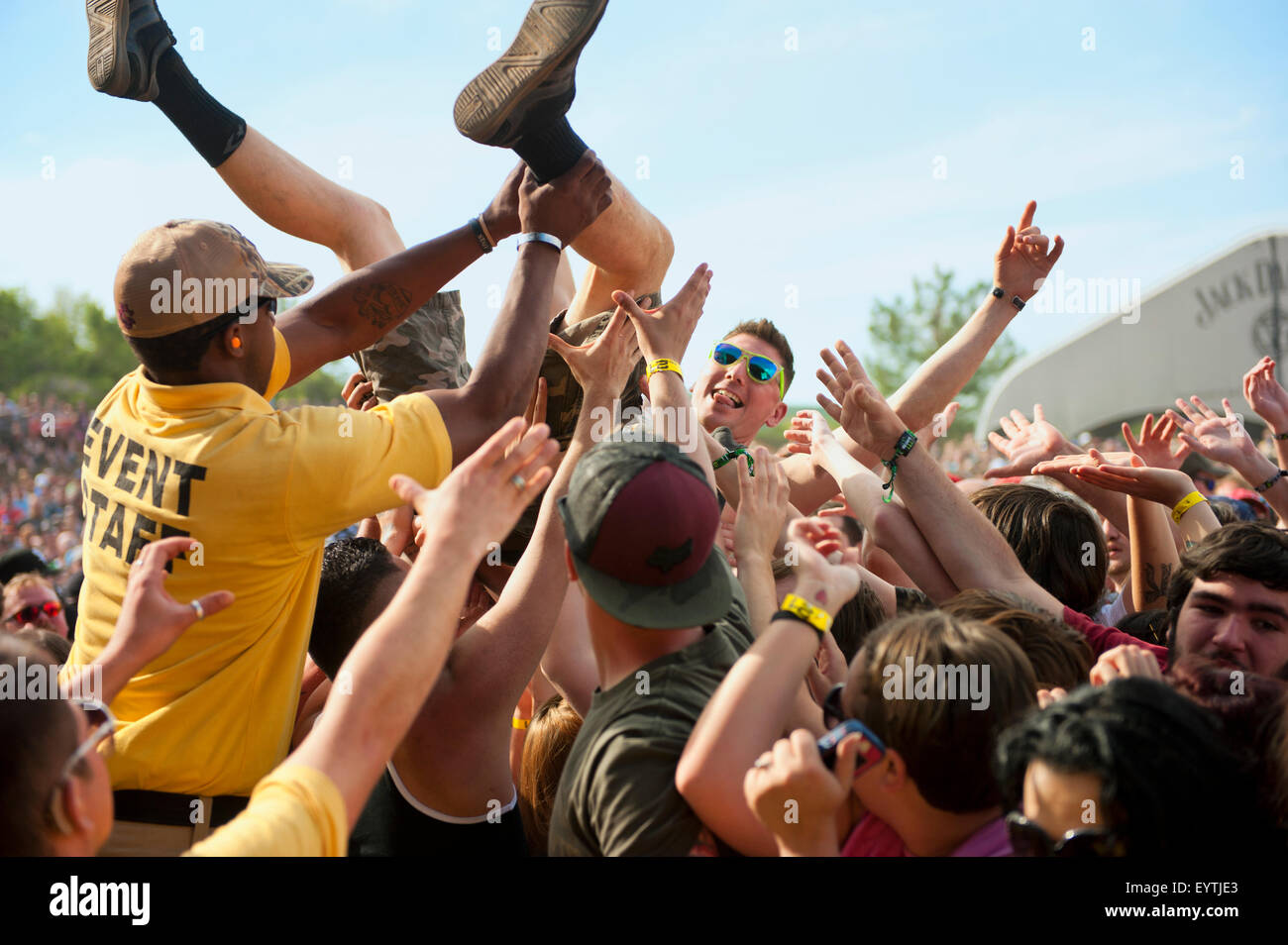 Crowd control worker catches a crowd surfer at the Heavy Metal music ...